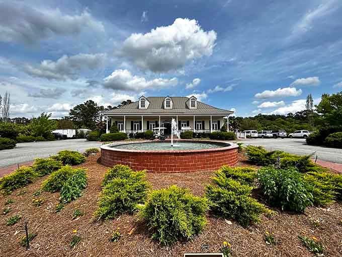 Dramatic clouds frame this charming entrance where manicured gardens meet Southern hospitality in perfect harmony and grace.