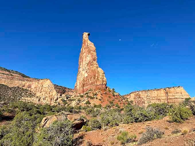 Independence Monument rises defiantly from the canyon floor, a solitary spire that's been standing guard since dinosaurs roamed here.