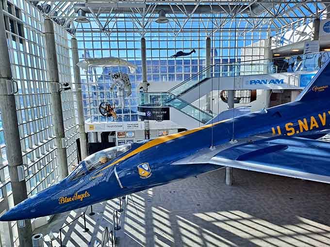Blue Angels jets hang suspended in dramatic formation, frozen mid-flight inside this cathedral dedicated to aviation pioneers.