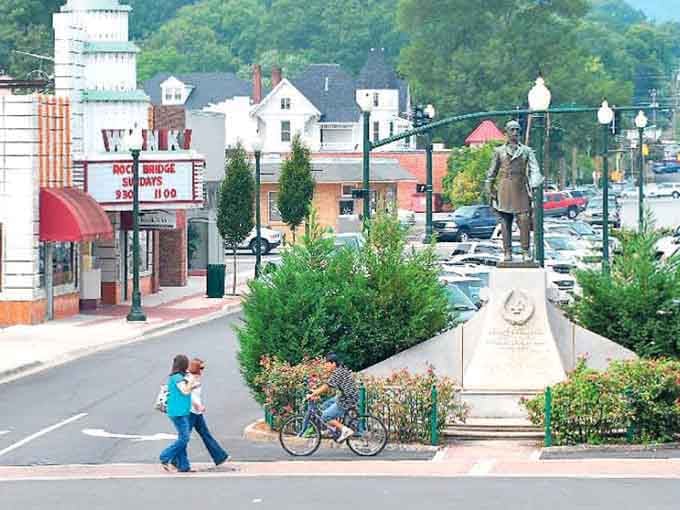 A monument stands watch over brick-paved streets, honoring history while the town moves forward with quiet dignity.