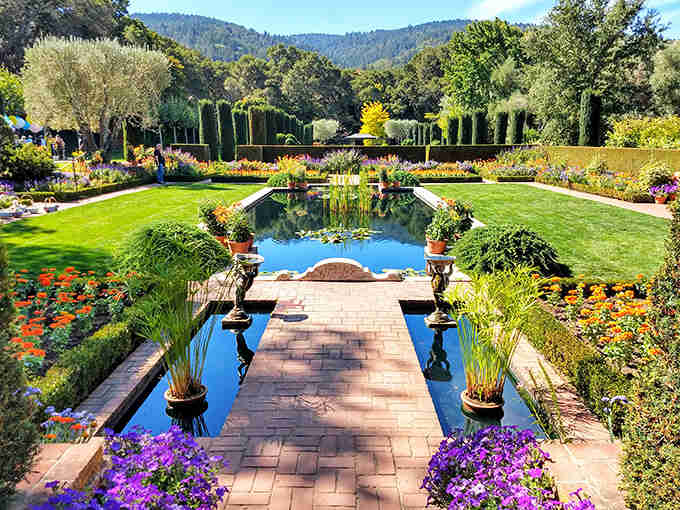 Purple blooms frame this garden paradise where every pathway leads to another breathtaking view worth savoring slowly.