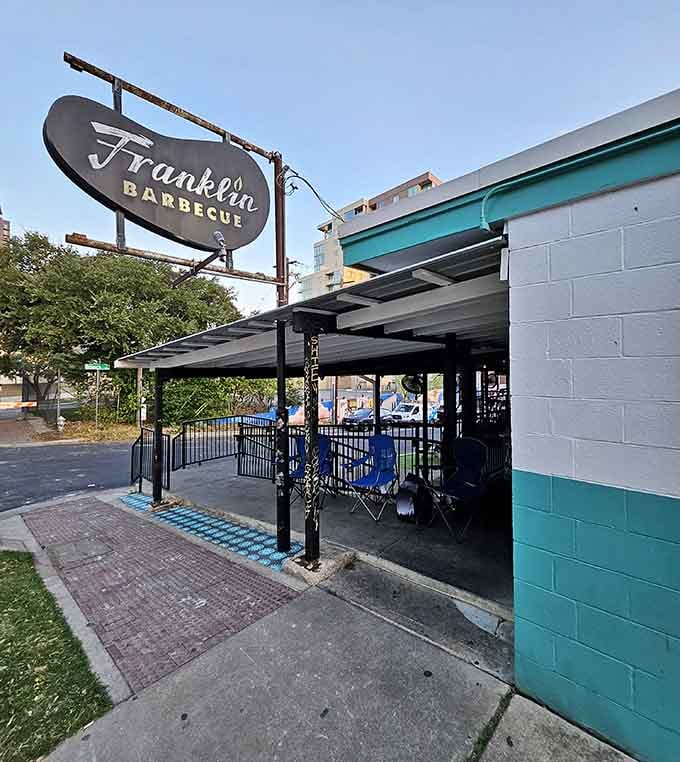 The vintage sign and covered patio create an urban oasis where city dwellers discover what real pit barbecue tastes like.
