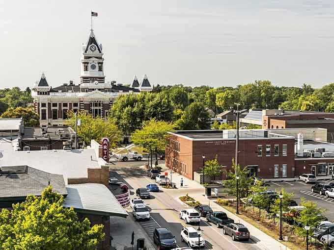 The courthouse clock tower rises majestically above spring's green canopy in this bird's-eye view.