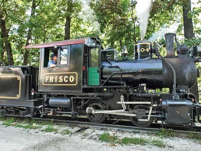 Steam billows from the authentic Frisco locomotive, its black boiler and green trim evoking memories of America's railroad heyday.