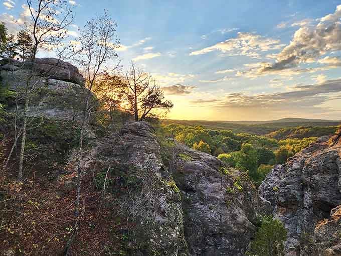 Golden hour light filters through ancient stones and autumn trees, turning this natural wonder into something almost impossibly beautiful.