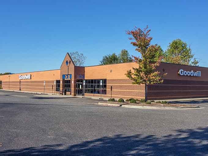 The warm brick facade and autumn trees create an inviting scene for your next thrifting adventure.
