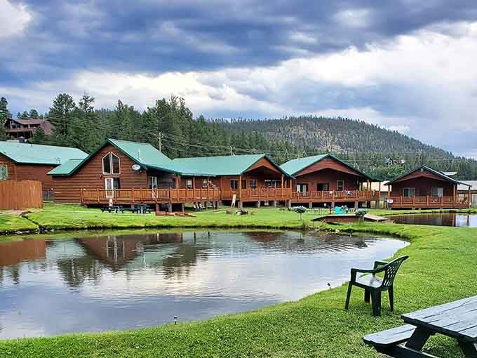 Log cabins reflected in still water prove that Arizona keeps secrets worth discovering in its high country hideaways.