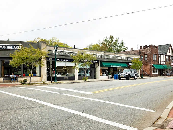 Tudor-style architecture mingles with traditional shops along tree-shaded streets where neighbors still greet each other by name warmly.