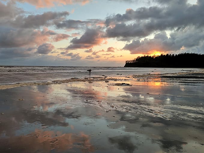 Sunset reflections turn wet sand into a mirror, doubling the beauty in this peaceful coastal moment.