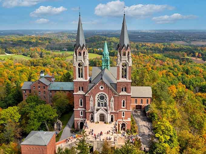 From above, the basilica crowns the hilltop surrounded by autumn's brilliant tapestry of reds and golds.
