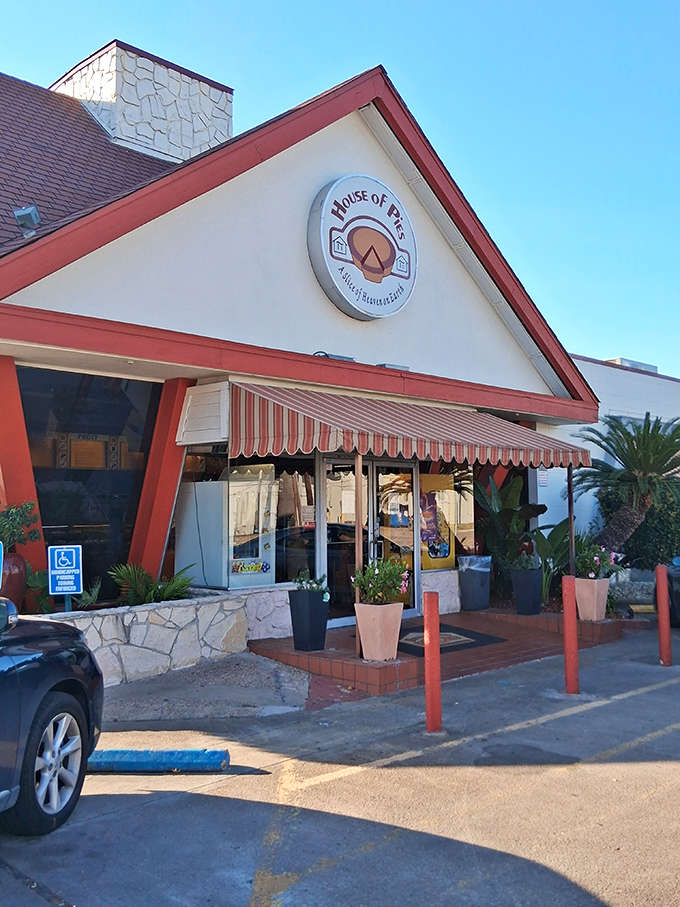 The striped awning and stone facade create a welcoming entrance to what locals know as their go-to dessert destination.