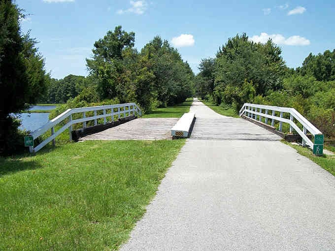 This peaceful trail stretches into the distance, perfect for morning walks or afternoon bike rides through nature.