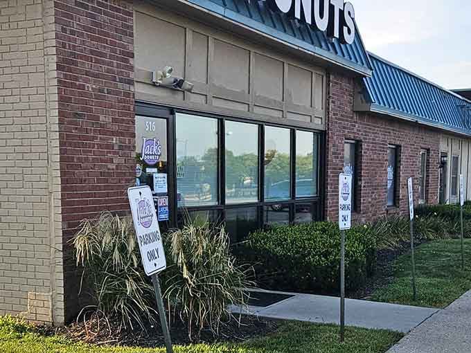 Seasonal decorations and manicured landscaping show the pride taken here, where attention to detail extends from storefront to every single donut.