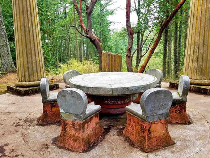 This eternal round table invites contemplation among towering columns where nature and memory create sacred space together.