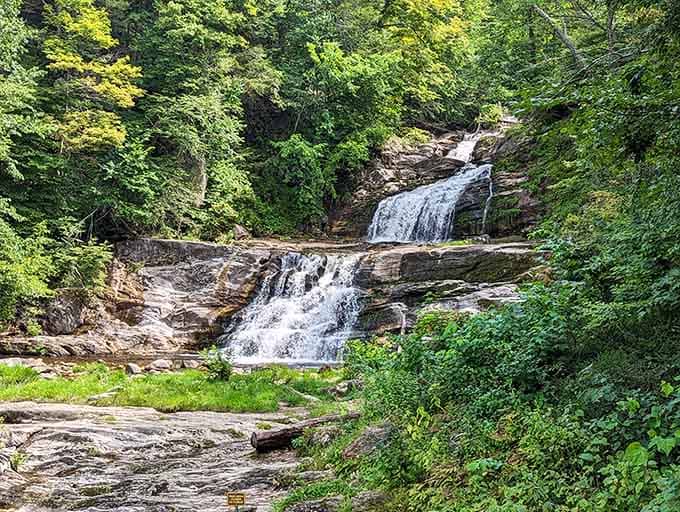 Water cascades down rocky ledges in multiple tiers, creating nature's own staircase of rushing white foam and mist.