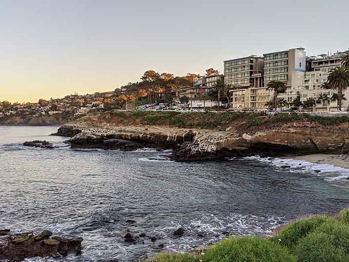 Golden hour transforms rocky coastline into a painter's dream, where waves whisper secrets to the ancient stones.