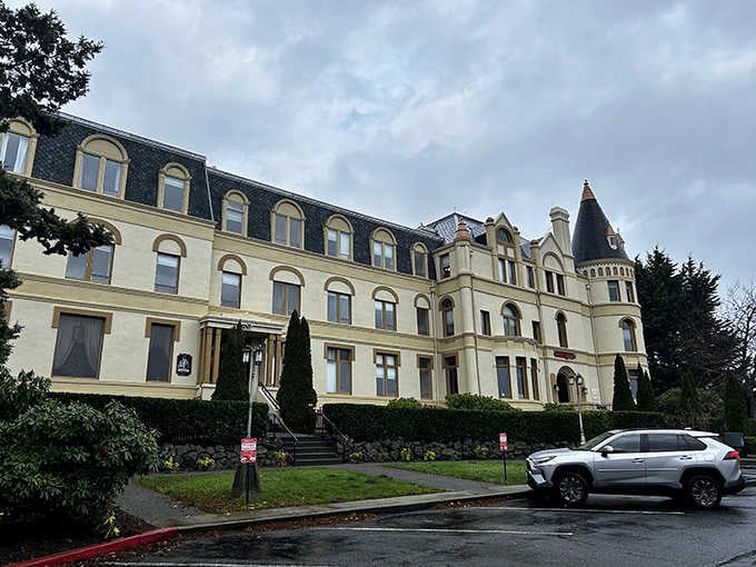 Mansard rooflines and elegant windows catch the light while manicured hedges add that finishing touch of class.