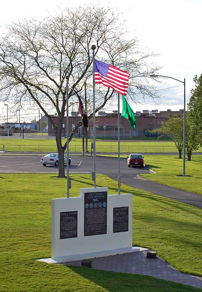 Green spaces and memorial flags remind us that small towns honor their heroes in the most visible places.