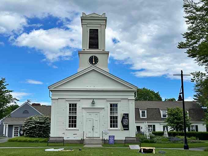 The pristine white church steeple stands as a timeless beacon in this recreated 19th-century coastal village setting.
