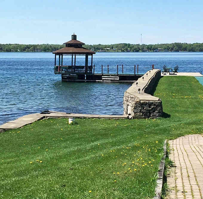 This charming gazebo pier extends over sparkling water, creating the perfect spot for morning coffee with million-dollar views on a modest budget.