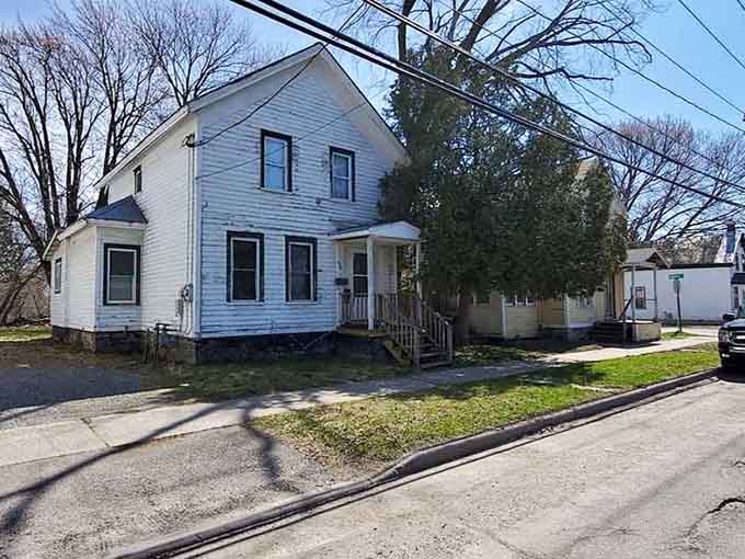 Simple white houses with front porches line quiet streets where kids still ride bikes and neighbors actually know each other's names.