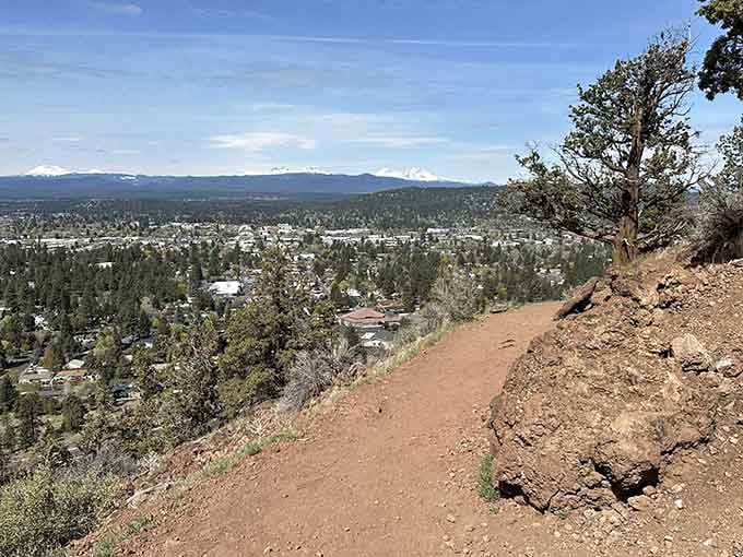 A stunning view unfolds from above, with the vast landscape stretching out toward the distant mountains.