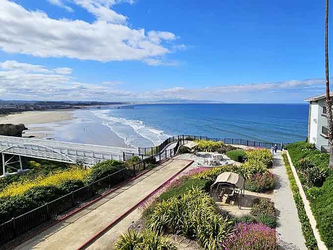 The terraced walkway overlooks miles of pristine beach where Pacific waves roll in with hypnotic rhythm and grace.