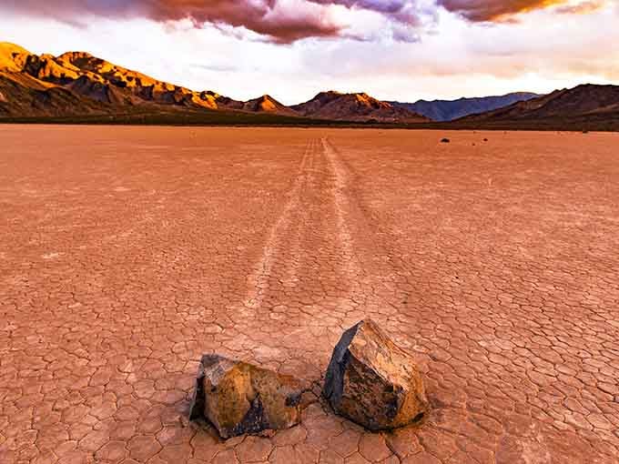 Dramatic skies frame the cracked earth where stones write their own stories, leaving tracks that puzzle and delight visitors.