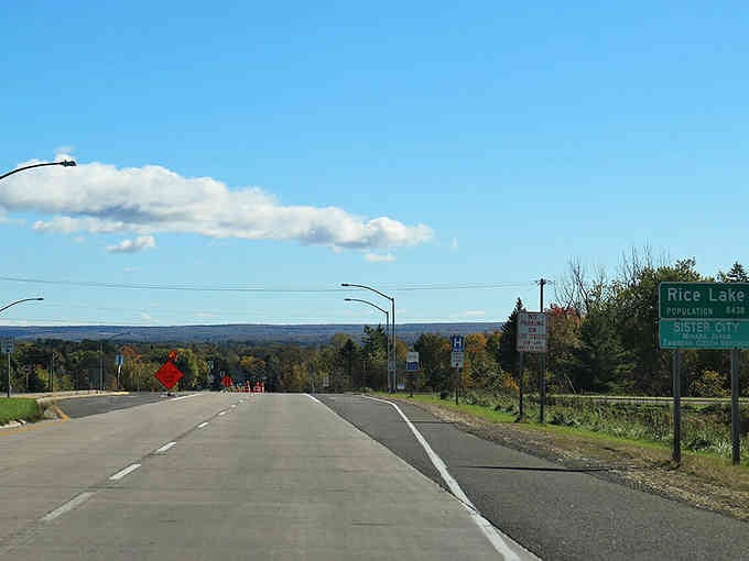 Autumn colors frame the highway entrance where affordable living waits just beyond that welcoming green sign.
