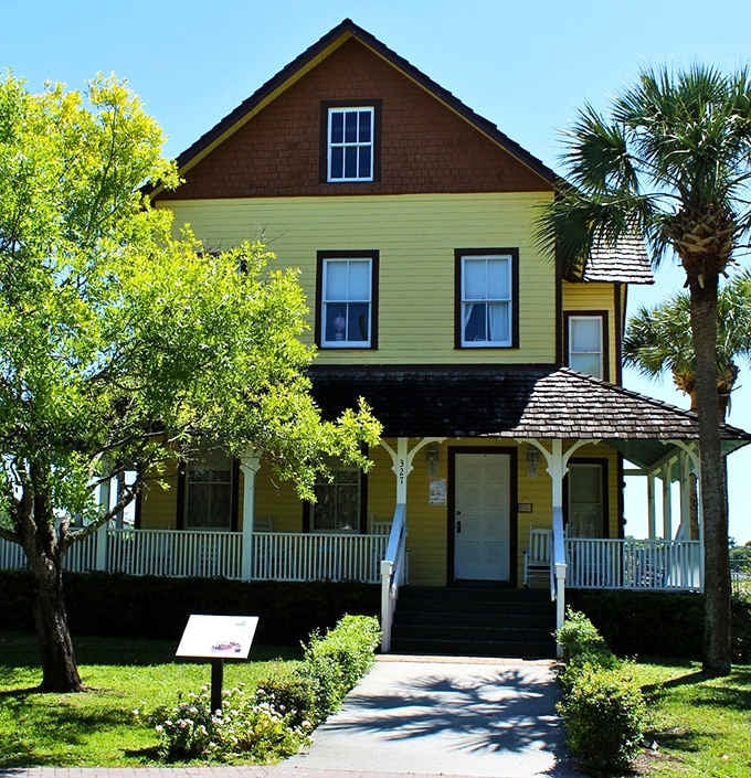 Palm trees frame the front porch of this historic home like natural sentinels guarding secrets from another era entirely.