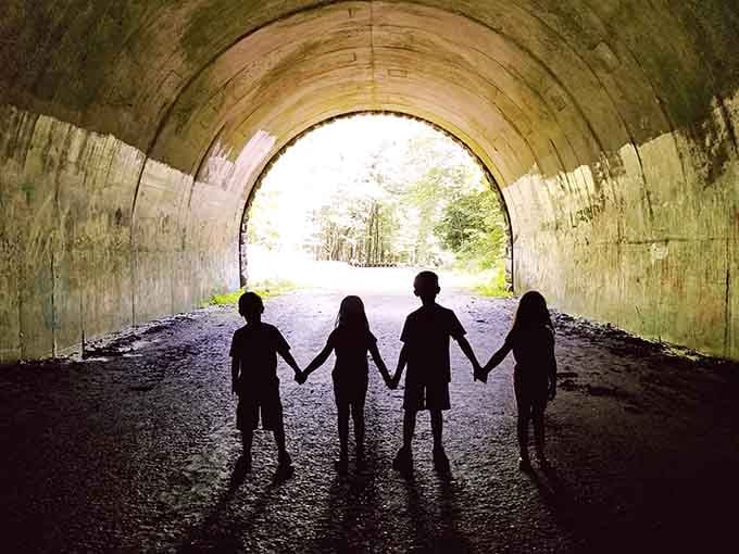Four silhouettes frame the light like a scene from Stand by Me's most memorable moment.