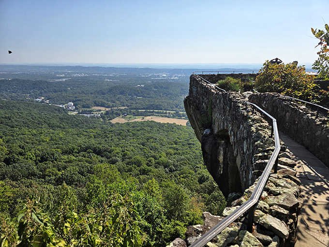 The dramatic rock outcrop juts into endless sky, offering views that stretch clear across multiple states below.