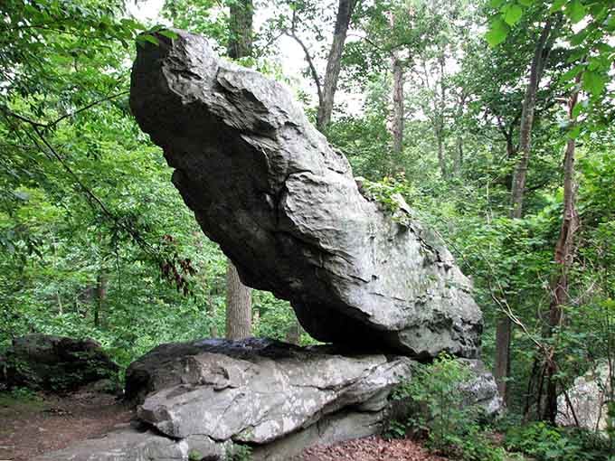 This massive boulder balances impossibly, defying gravity since your grandparents were probably learning to drive stick shifts.