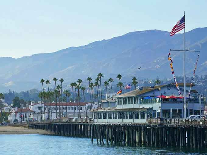 Palm trees march in formation along the historic wharf, where ocean breezes carry the promise of endless summer days.