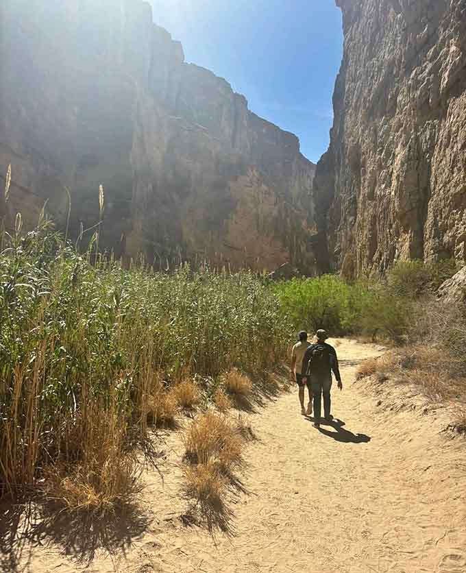 Those hikers ahead give perfect scale to these massive cliffs, proving that sometimes the journey really is the destination.