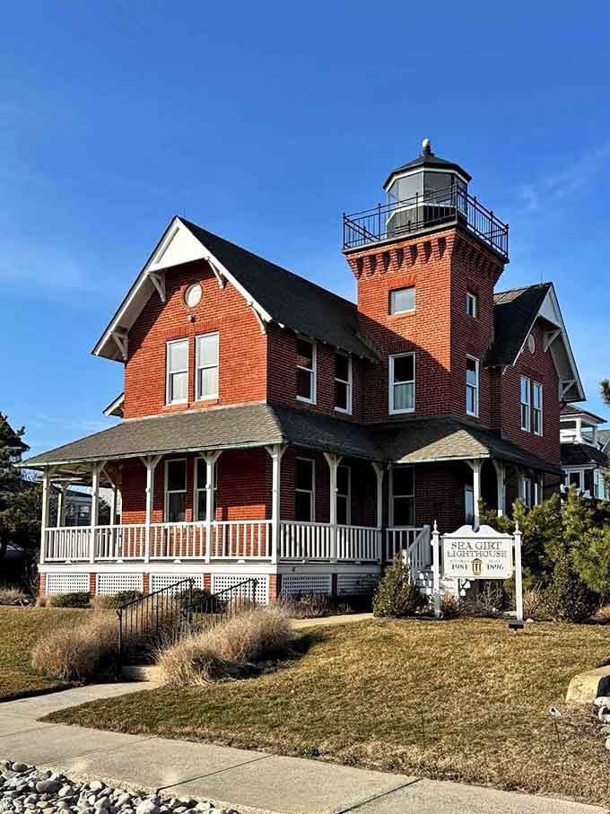 Wrapped porches and red brick charm make this lighthouse look more like your favorite aunt's cozy cottage.