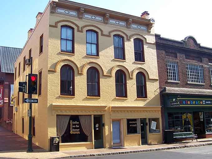 That butter-yellow facade with arched windows looks like it wandered over from a Mediterranean coastal town.