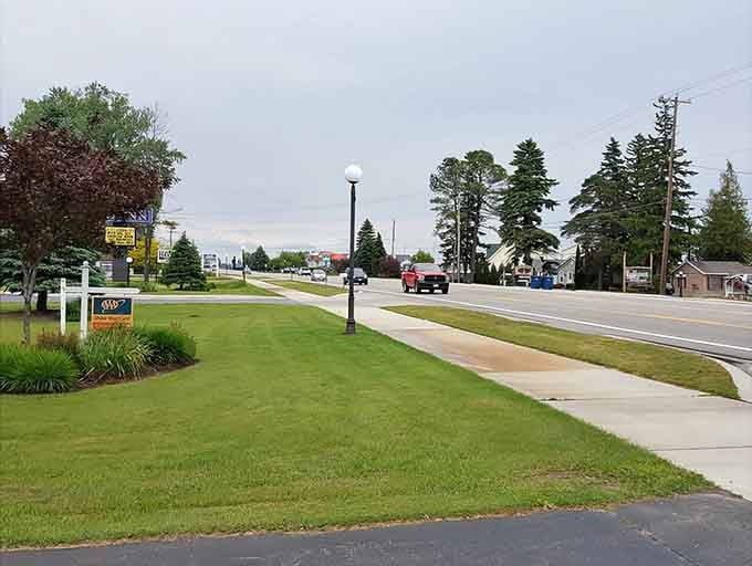 Manicured lawns and pine trees frame a highway that leads to surprisingly affordable lakeside living.