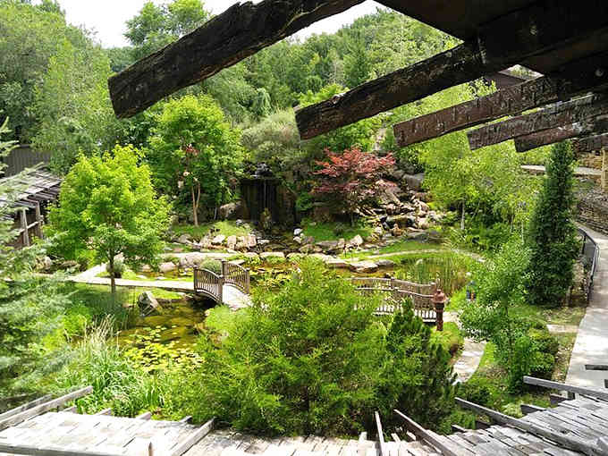 Lush greenery cascades over multiple levels while walkways twist through spaces that defy logic and embrace pure creativity.