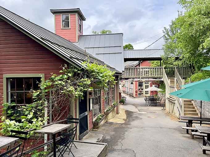 The rustic mill buildings house treasures within, their weathered charm promising adventures waiting on every shelf inside.