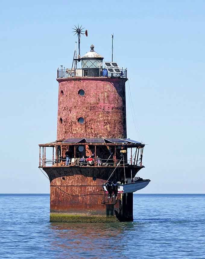 The weathered patina tells stories of countless tempests while modern equipment keeps the maritime world spinning safely forward.