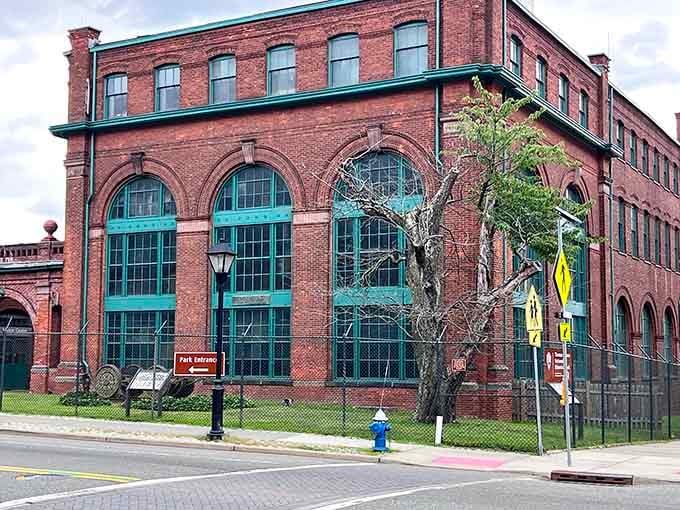 The industrial red brick buildings stand proudly, their arched windows reflecting an era when American ingenuity changed everything.