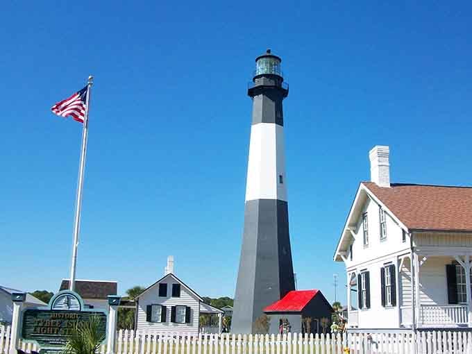 The classic lighthouse stands sentinel in black and white stripes, a beacon that's been guiding souls home for generations.