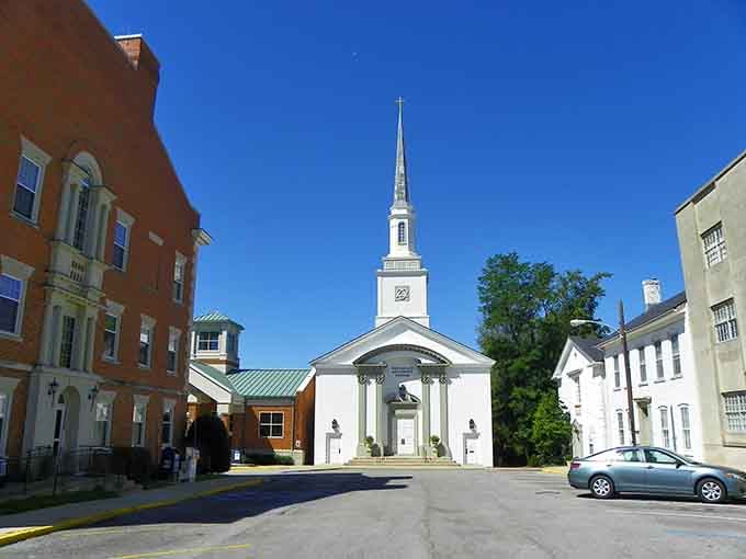 The white steeple church stands as a beacon of faith and community in this timeless downtown setting.