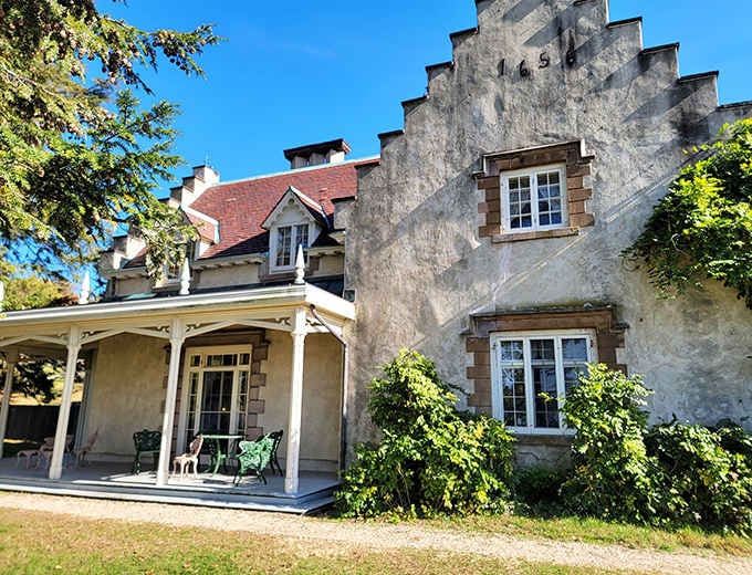 The weathered walls and peaceful porch suggest a writer's retreat where creativity flows like the nearby Hudson.