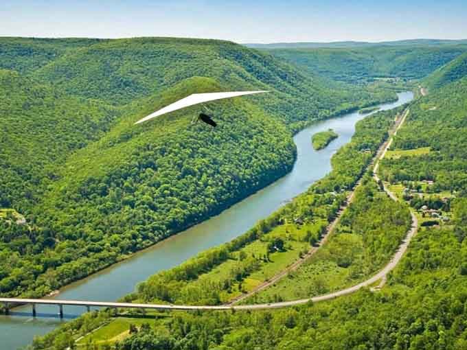 Endless green valleys and that silvery river ribbon prove Mother Nature's still the best landscape architect around.