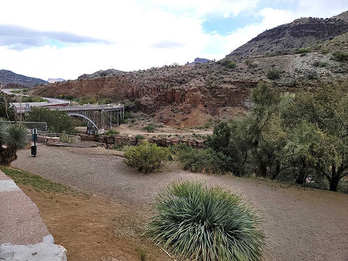 Where desert plants meet flowing water, this peaceful spot offers shade, serenity, and a bridge to somewhere wonderful.