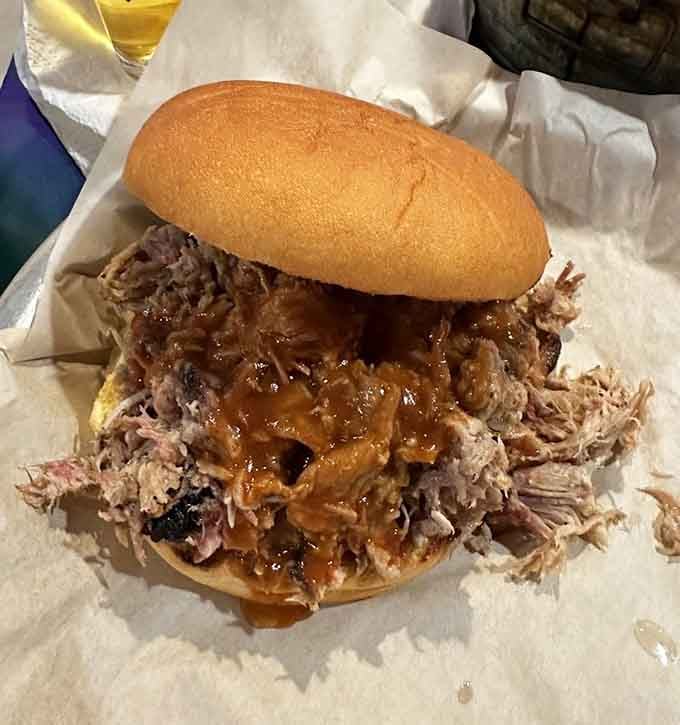 This towering pulled pork sandwich requires both hands and possibly a structural engineer to navigate properly.