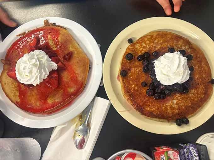 Pancakes crowned with whipped cream and berries turn breakfast into the dessert you actually deserve.