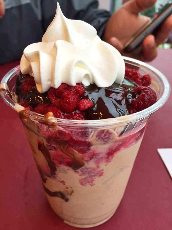 Hot fudge and caramel transform simple custard into a sundae that could easily qualify as performance art.